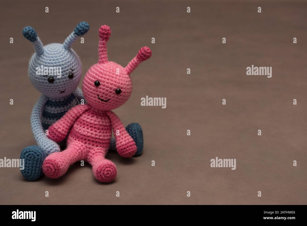 Two knitted bumble bee toys. One pink, one blue. Ideal to use for ...