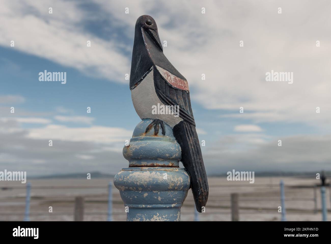 Metal magpie sculpture on top of metal post on the old stone jetty in ...