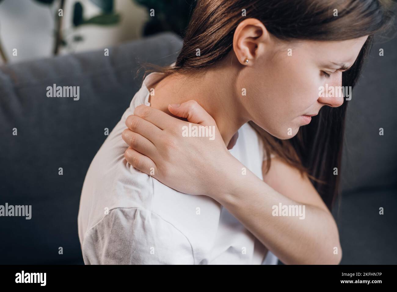 Close up of tired unhappy young caucasian woman massaging rubbing stiff ...