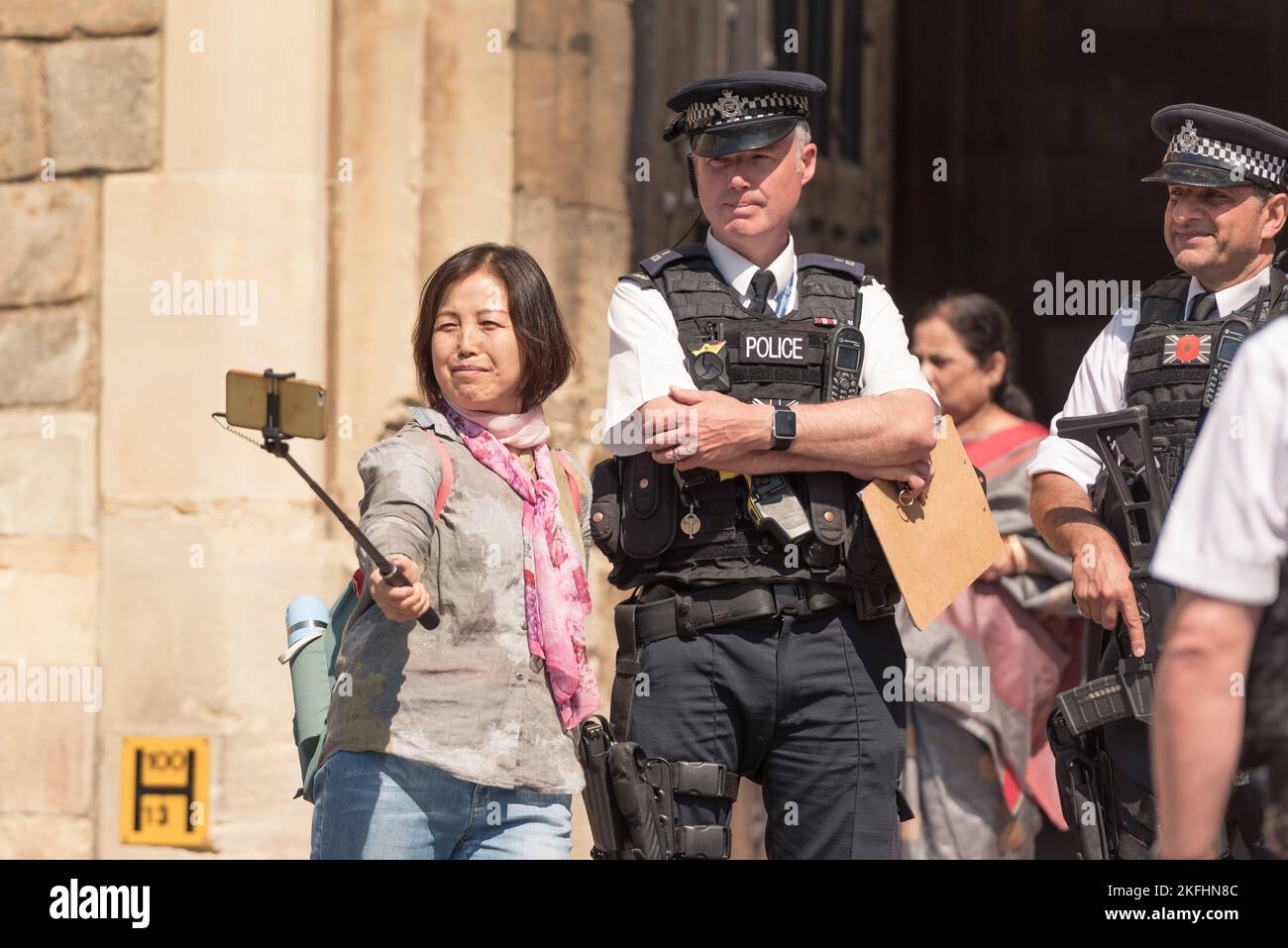 Tourist taking a selfie at Windsor Castle with the police men guarding the entrance. Windsor ...