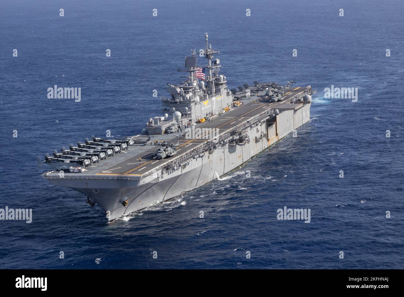 Amphibious assault carrier USS Tripoli (LHA 7) sails in the East China Sea during a photo ...