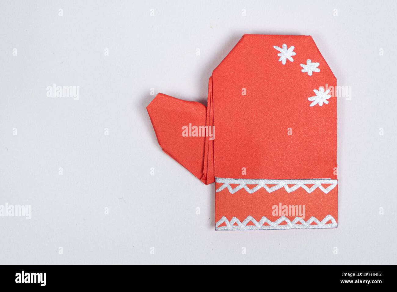 Christmas origami mitten paper on a white background, DIY for the New ...