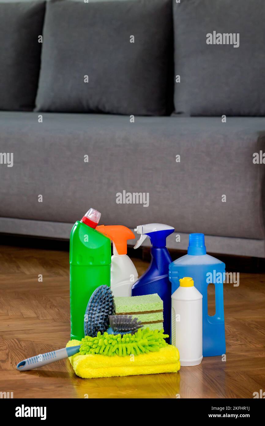 Containers with liquids for cleaning the house and various rags ...