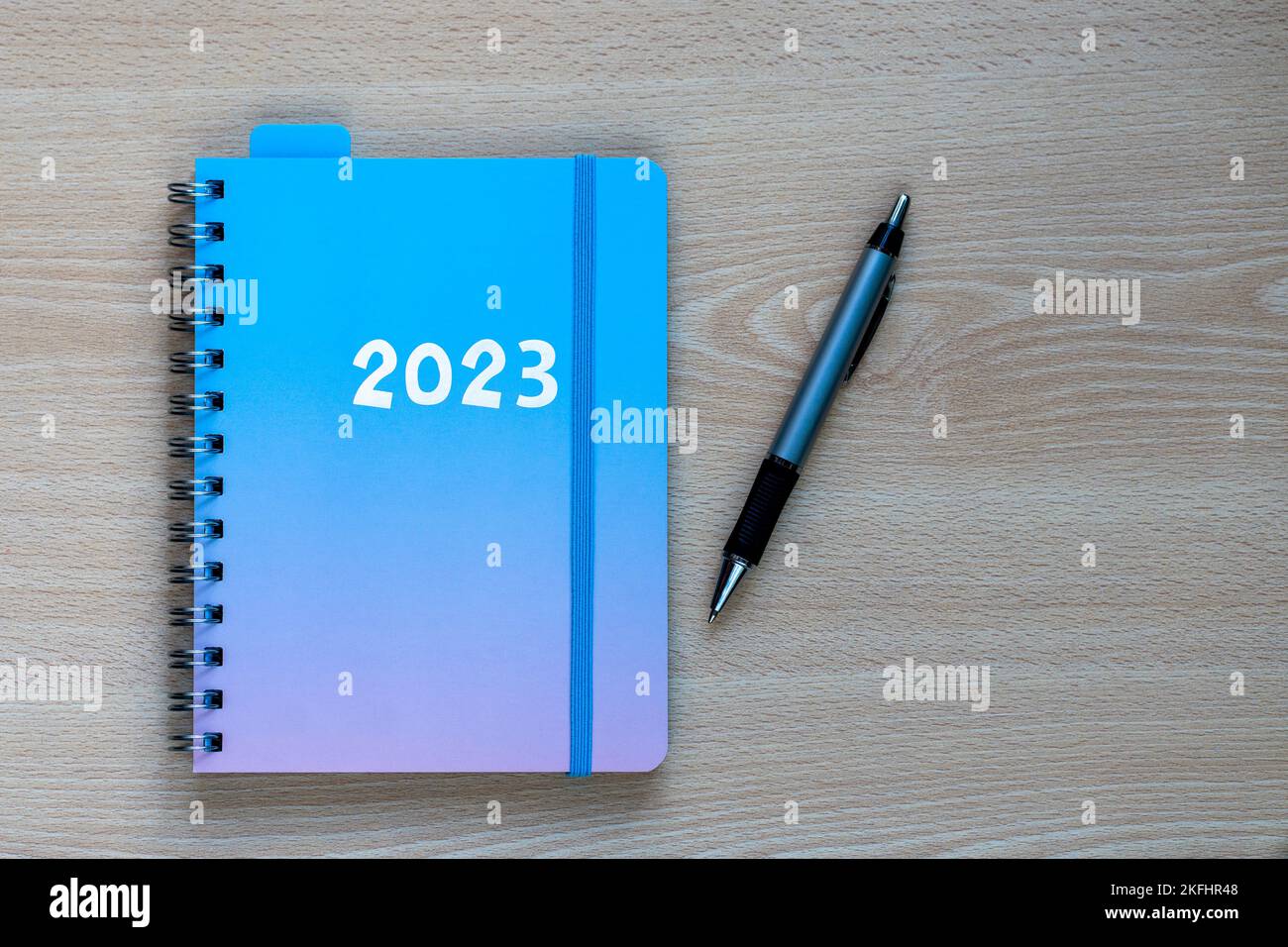 2023 diary to implement resolutions and new year plan on desk with a ...