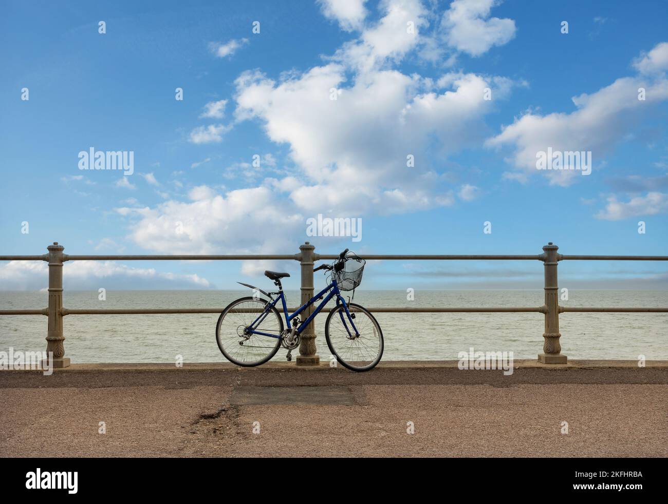 push bike lent against railings, with a sea view and blue sky Stock ...