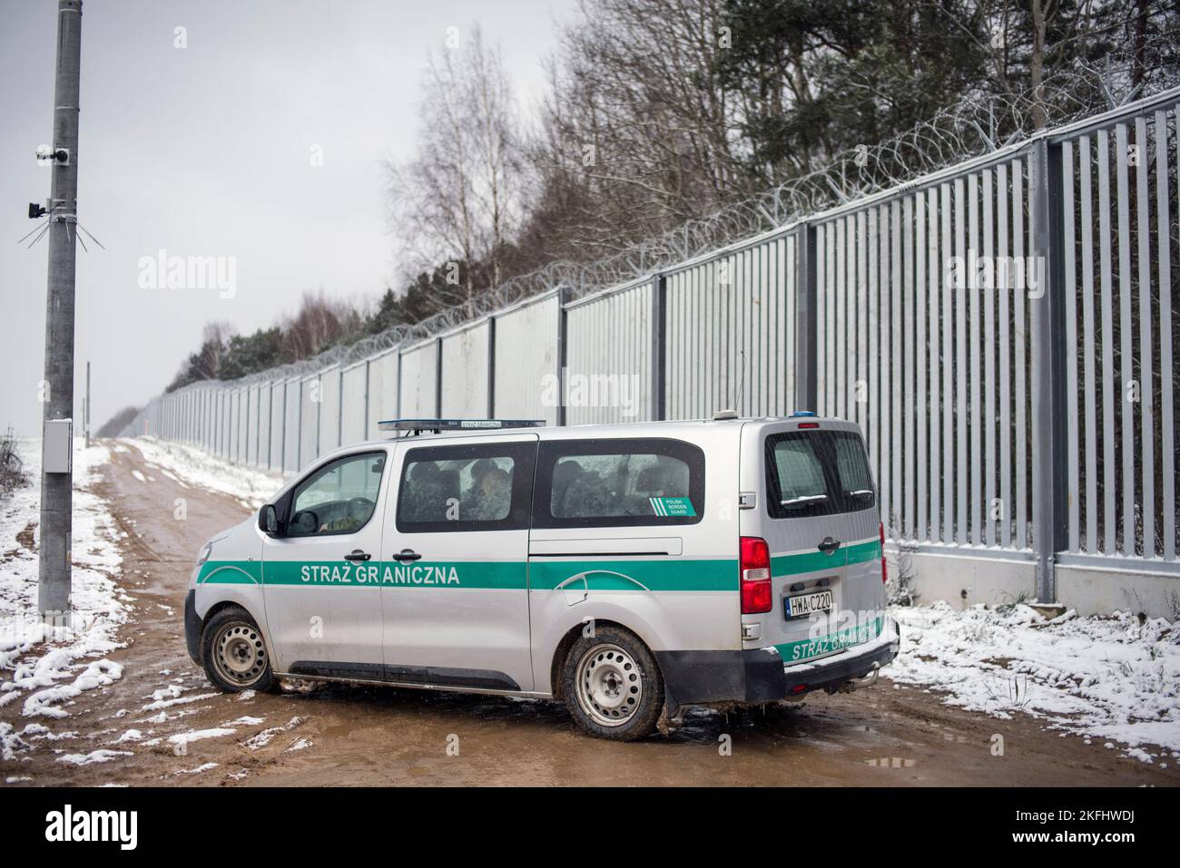 Polish border guard patrol vehicle is seen next to the metal border ...
