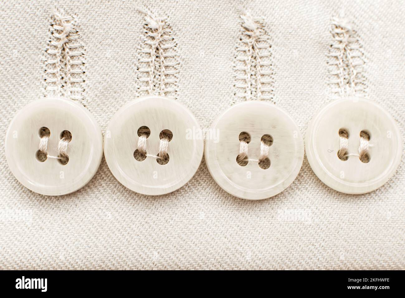 Buttons on the sleeve of a white men's jacket. White button closeup ...