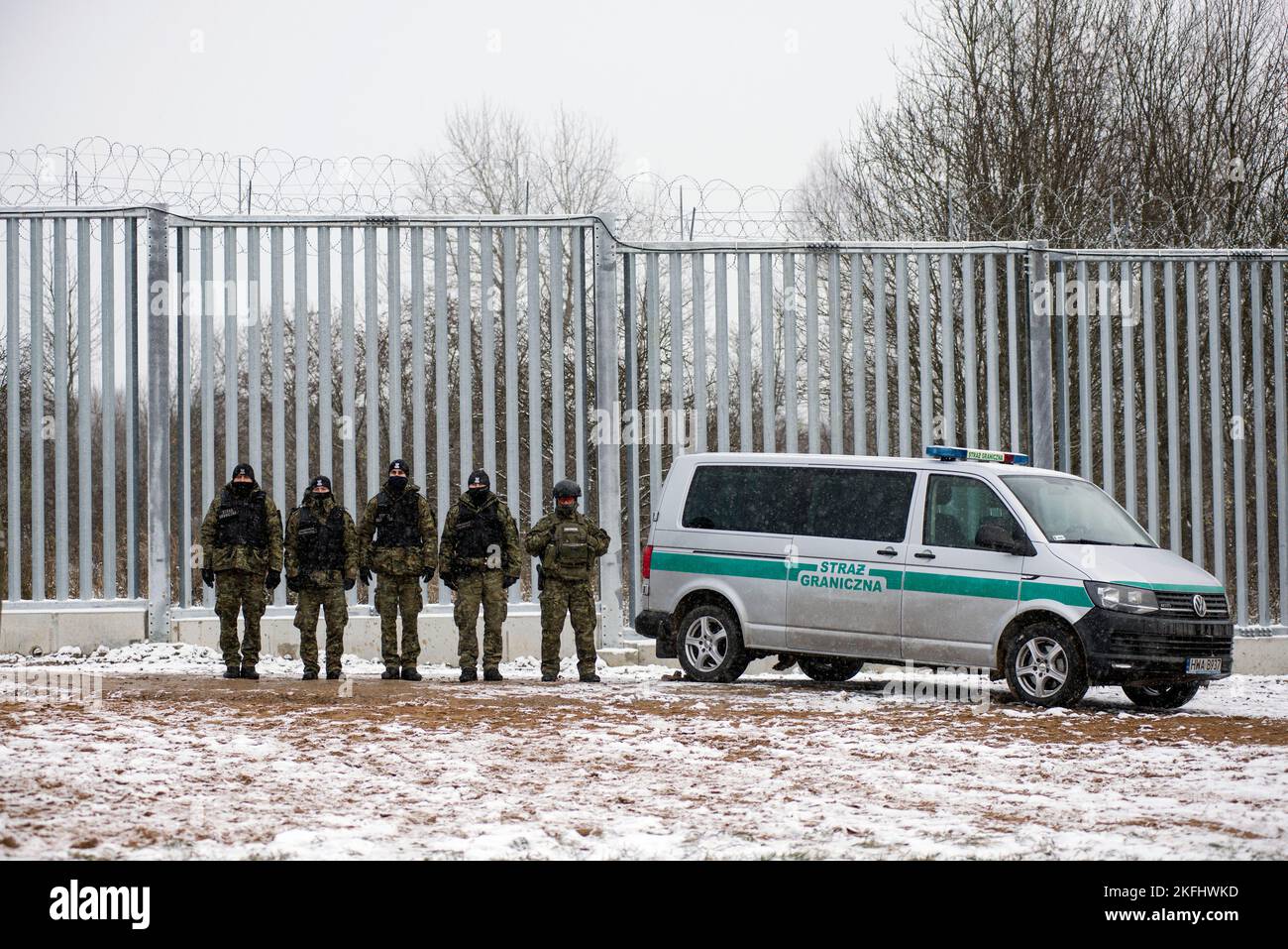 Armed border guards are seen guarding the border wall dividing Poland ...