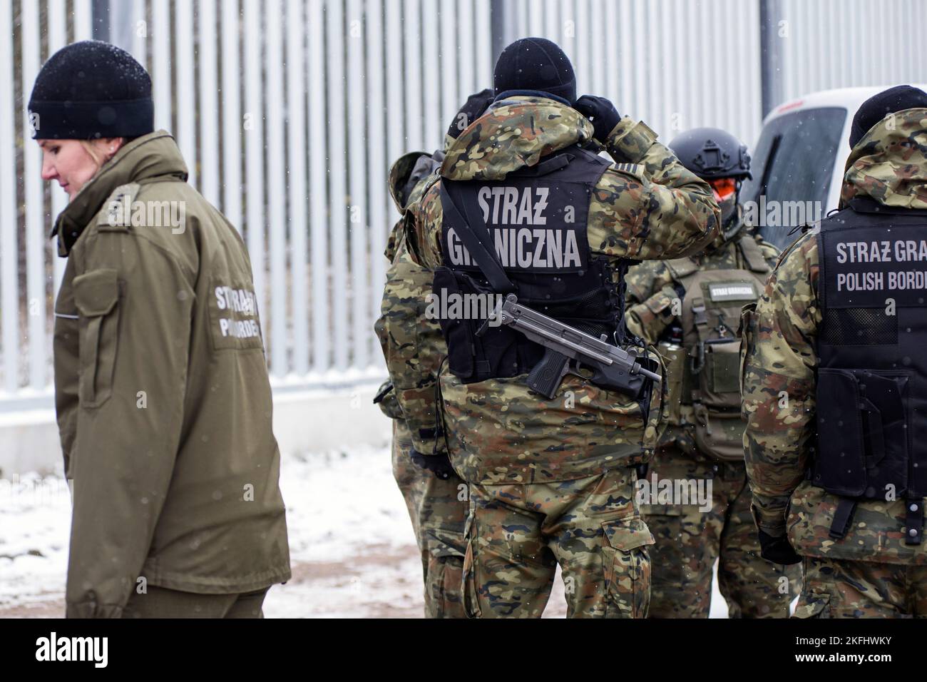 Armed border guards are seen guarding the border wall dividing Poland ...
