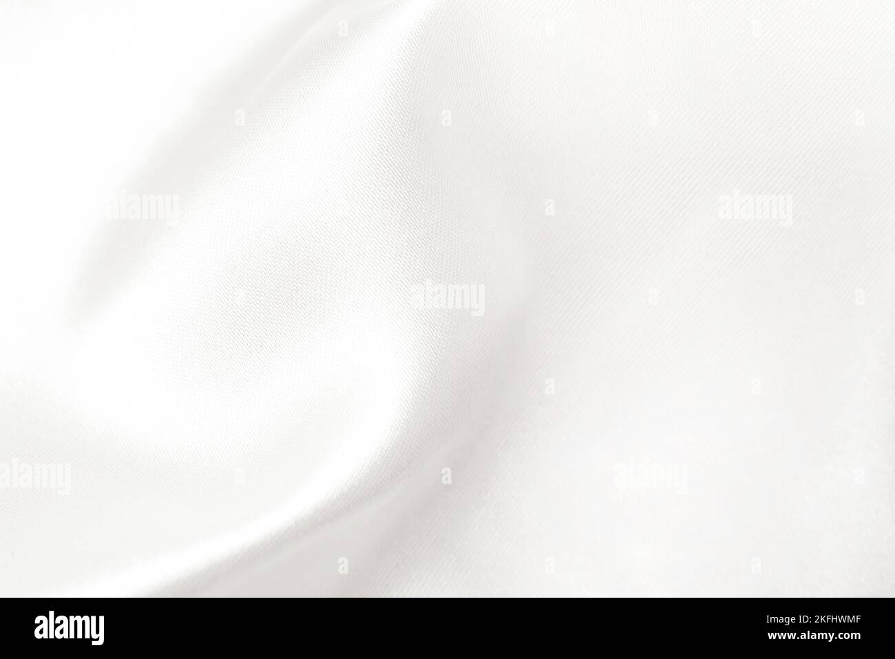 The texture of a fabric made of silk or calico with waves and rumples ...