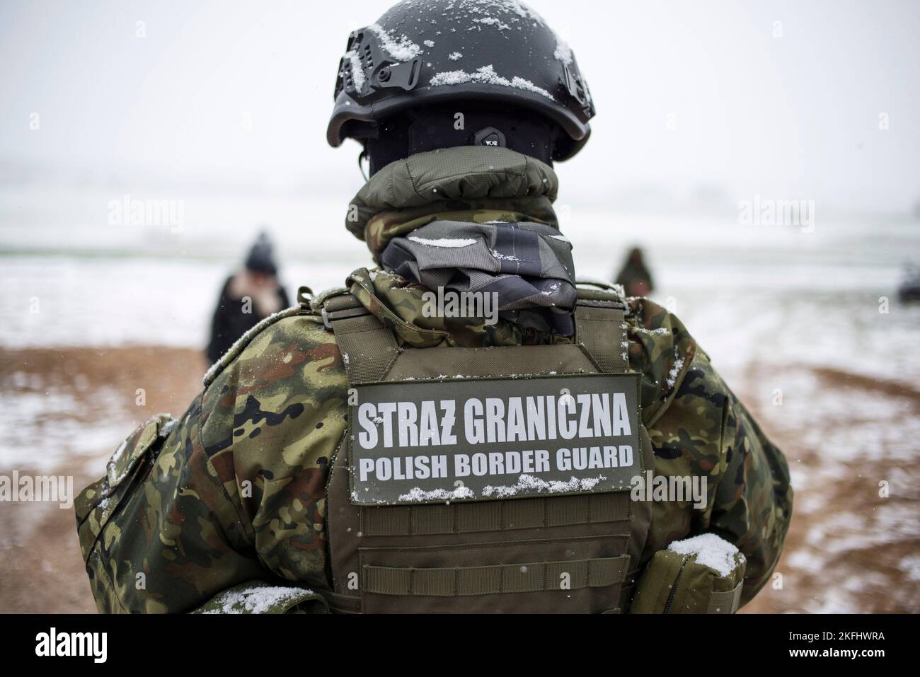 A border guard is seen guarding the border line with Belarus. Poland's ...