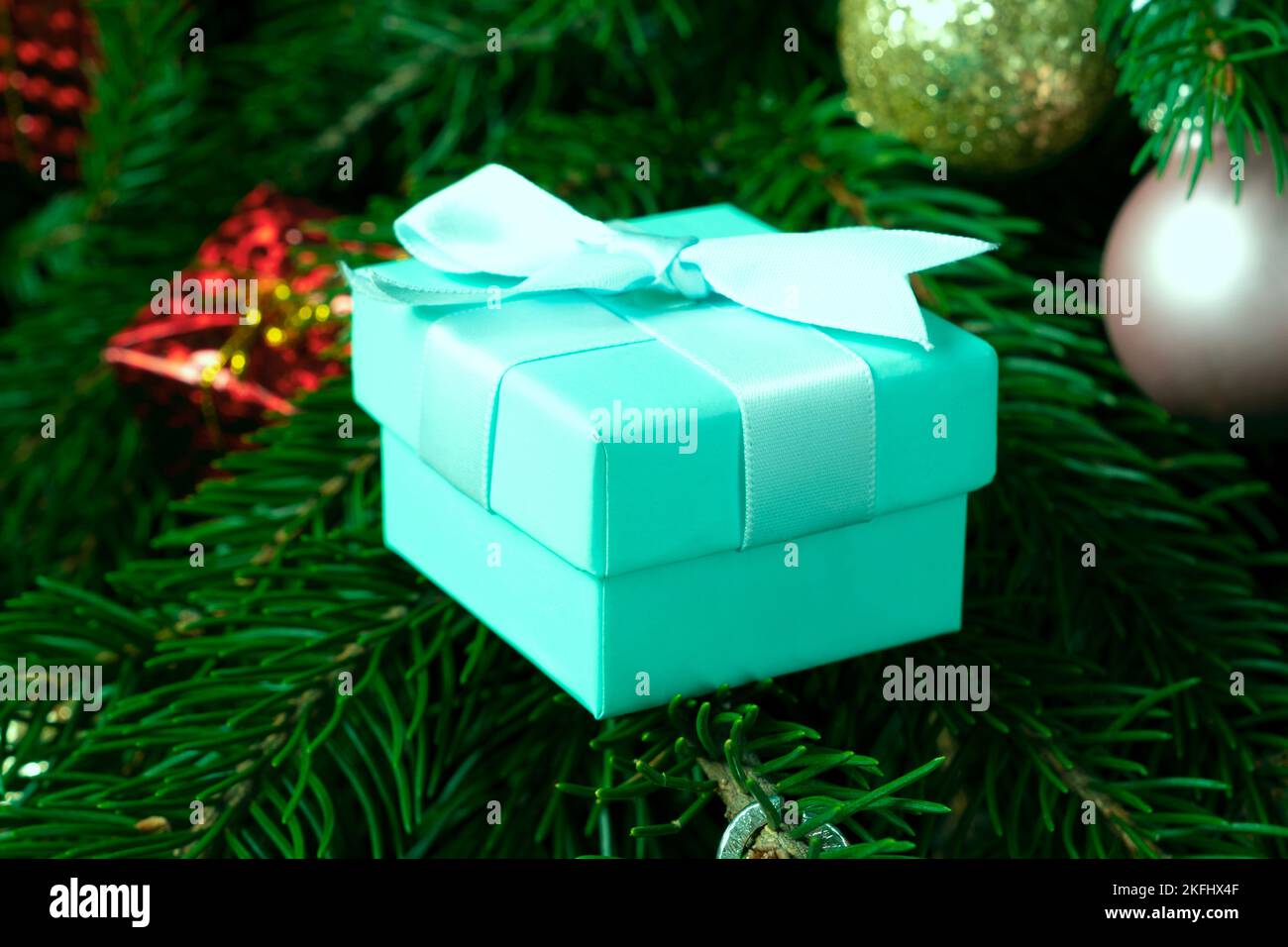 Christmas gift on the background of the Christmas tree close-up Stock ...