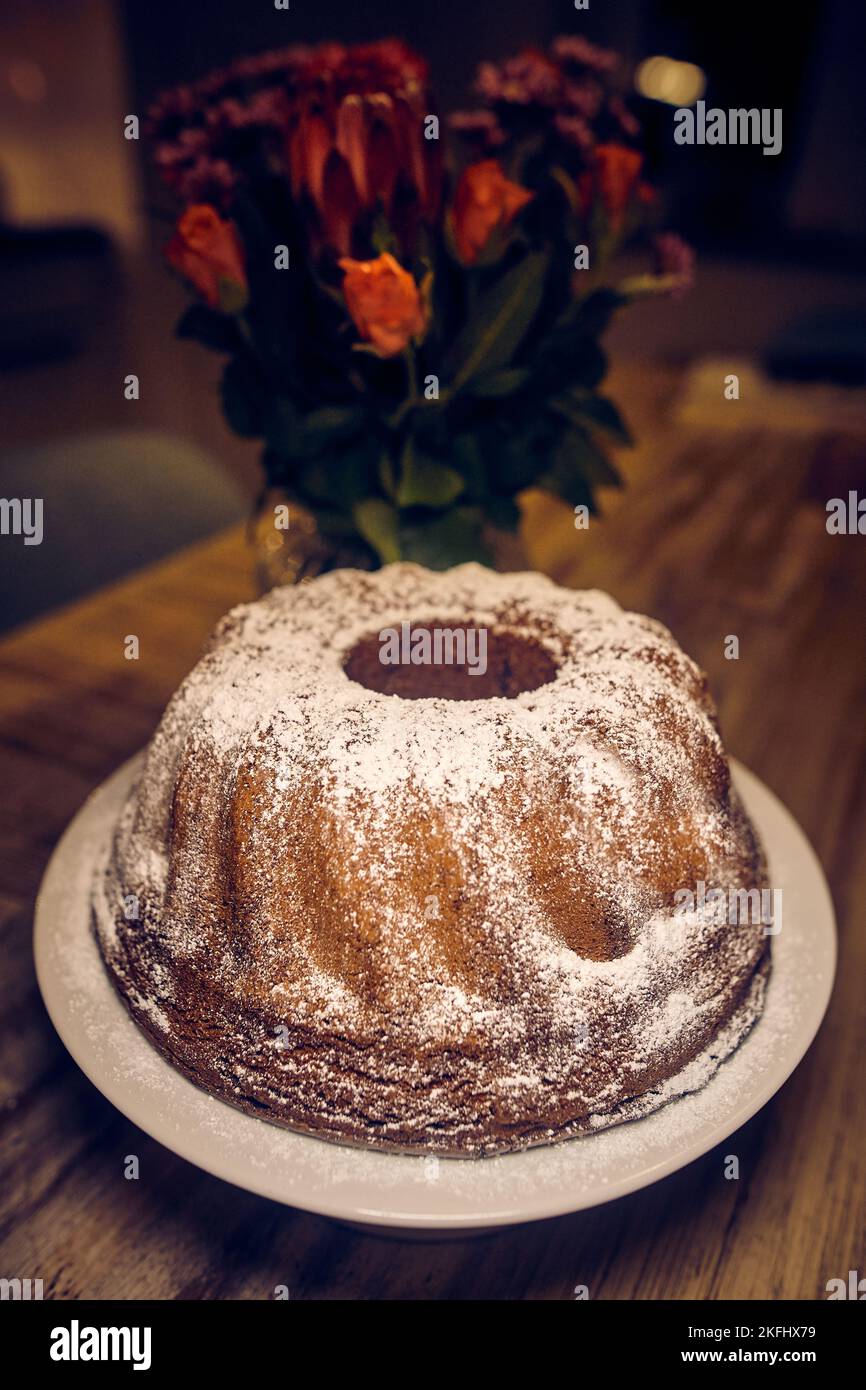 A freshly baked homemade delicious bundt cake covered in sugar powder ...