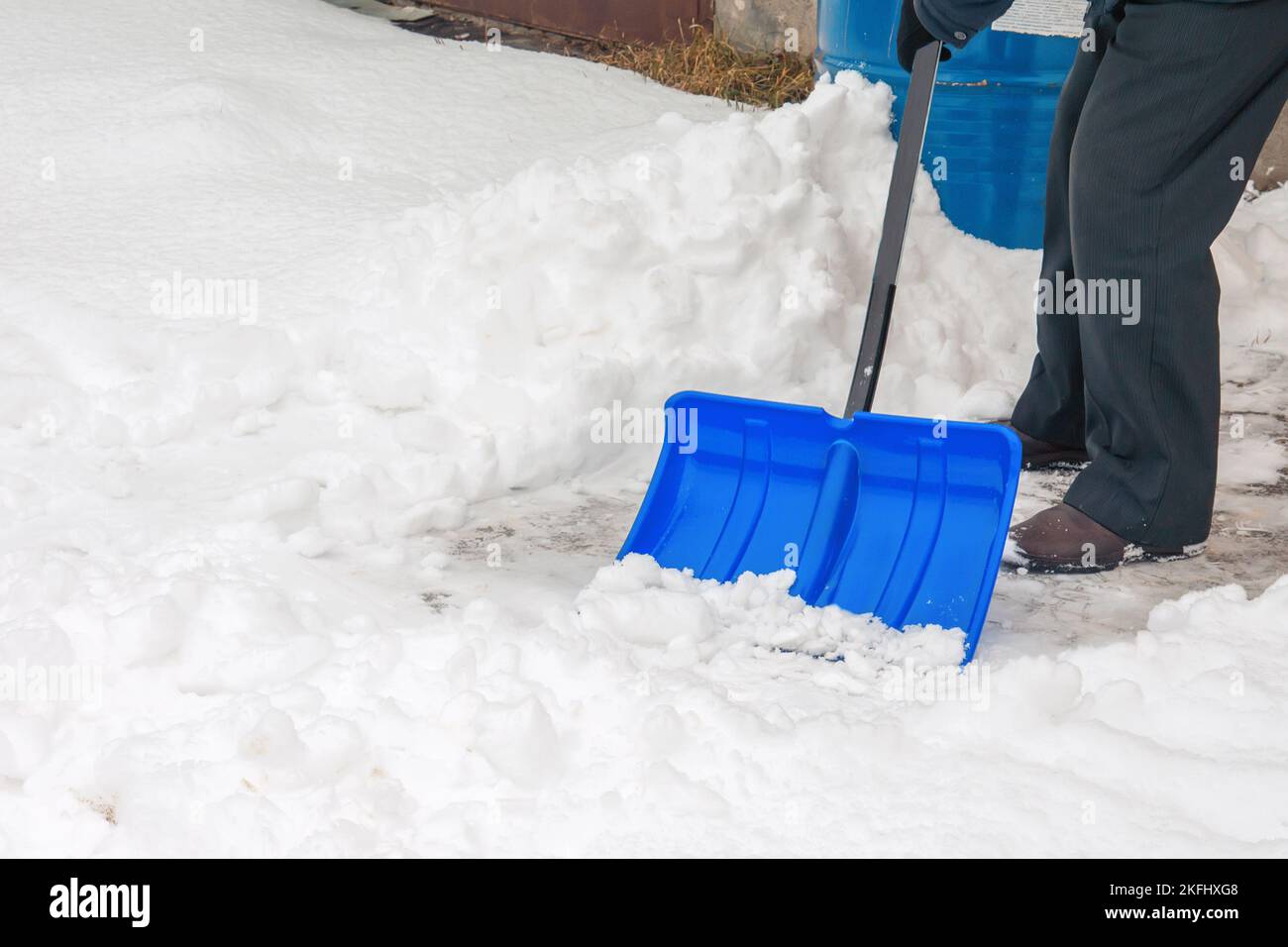 Man clearing snow by shovel after snowfall. Outdoors Stock Photo - Alamy