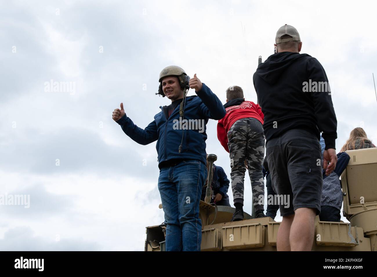 A Czech local poses atop a 4th Infantry Division M1A2 Abrams main ...