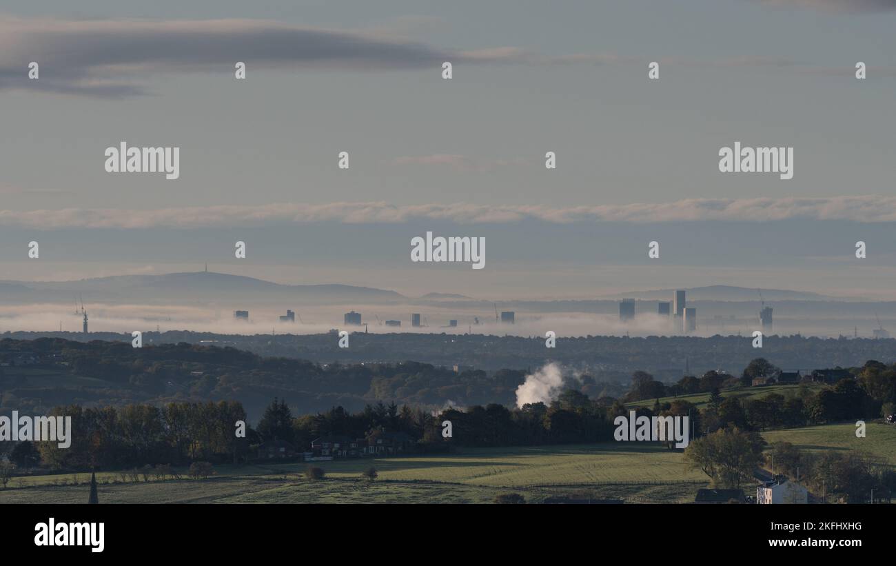 Dramatic landscape of the Manchester sky line. Low cloud and list with ...