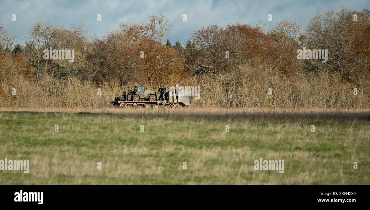 British army MAN HX77 8x8 logistics truck with armed rooftop soldier in ...