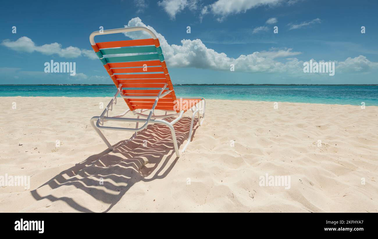 A lounge chair on the sandy beach with a scenic seascape view Stock ...