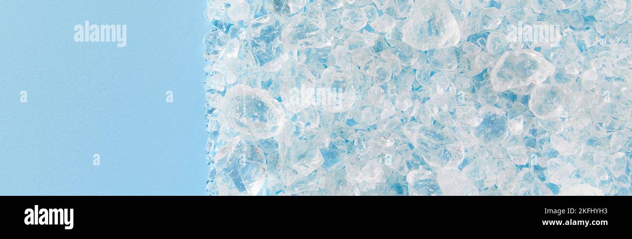 Close up crushed ice in sunlight on blue with copy space. Summer ...