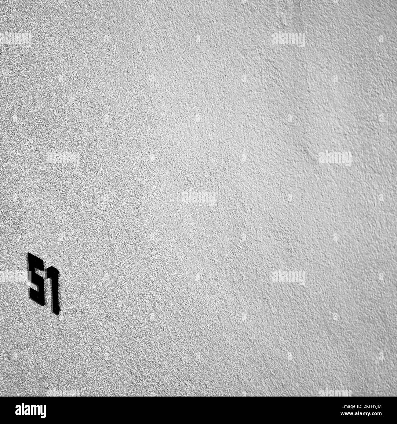 A grayscale closeup of number 51 on a textured wall Stock Photo - Alamy