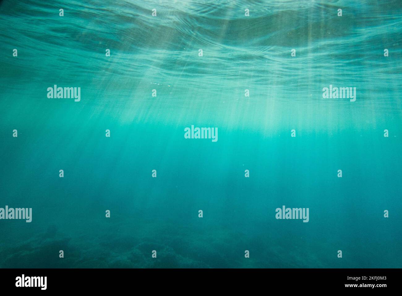 Sunlight streaming in deep idyllic blue seascape during sunny day Stock ...