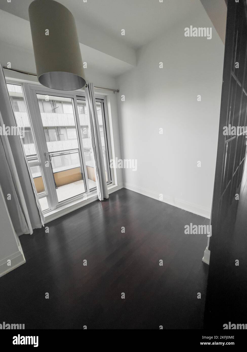 Sliding door in balcony and pendant light hanging on ceiling in empty ...