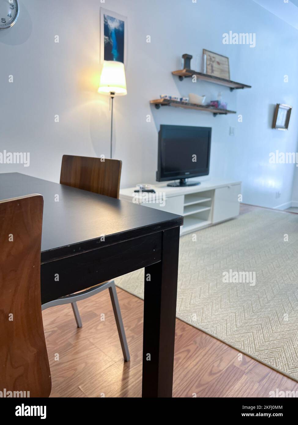 Decors places over television set by illuminated floor lamp and dining ...