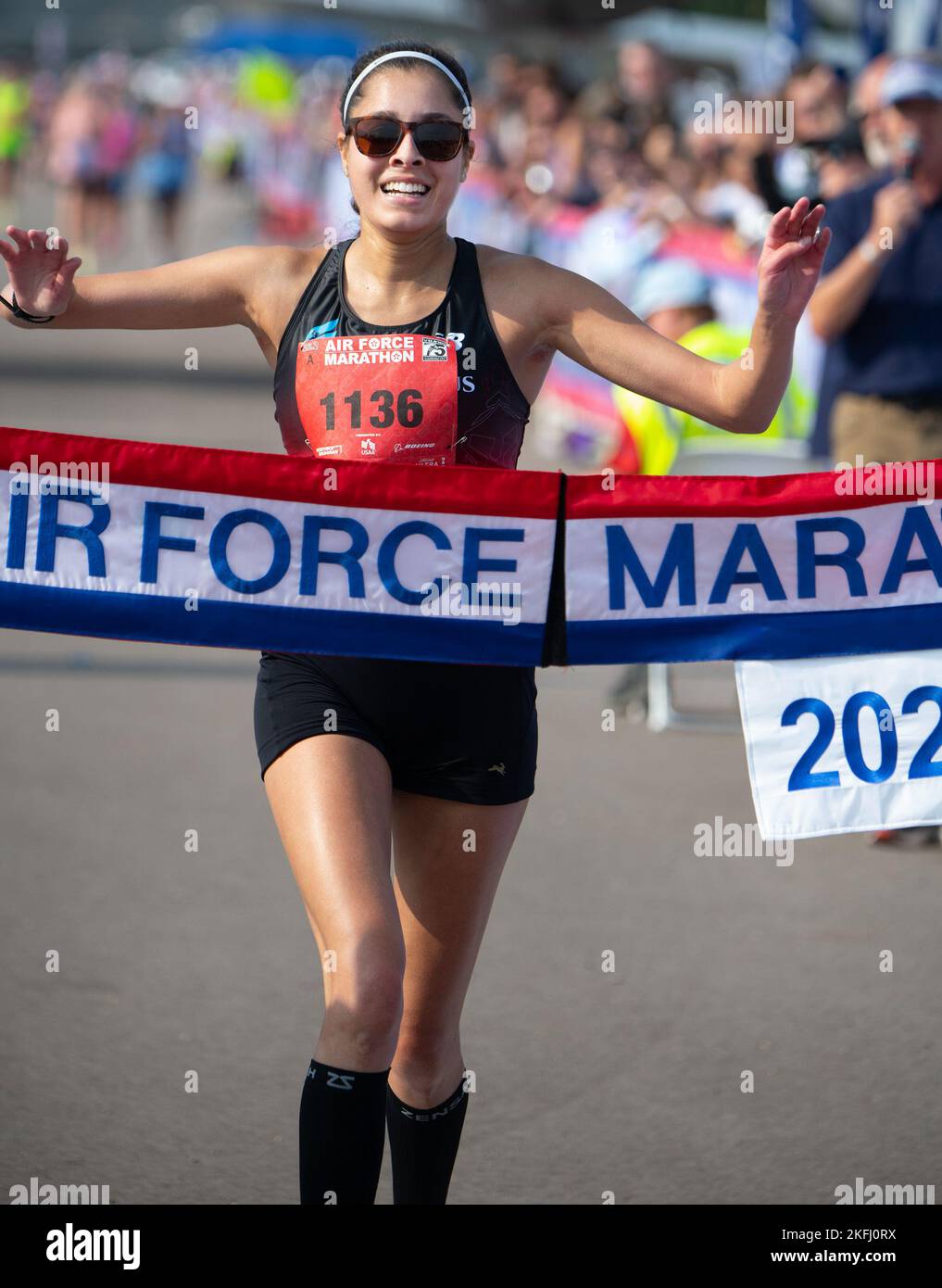 Gabby Bobadilla breaks the finishing line banner with a time of 3:00:07 winning the female ...