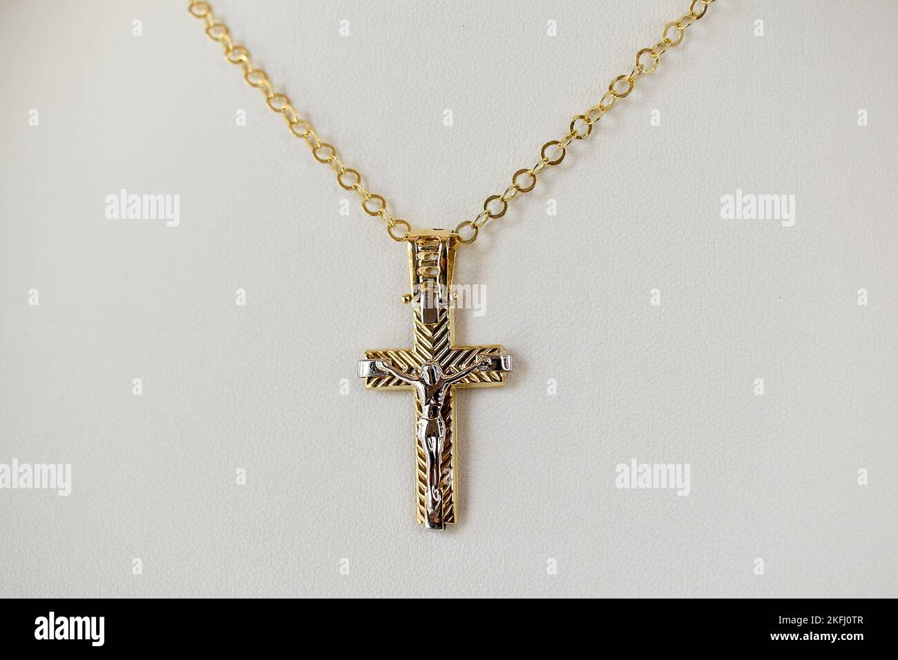 A golden cross necklace isolated on white background Stock Photo - Alamy