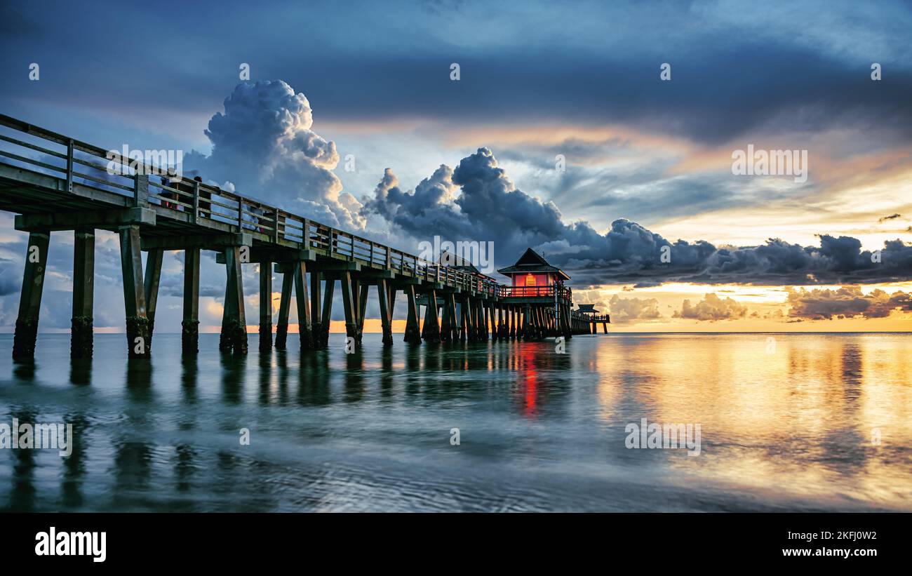 The beautiful Old Naples Pier over water in Florida at sunset Stock ...