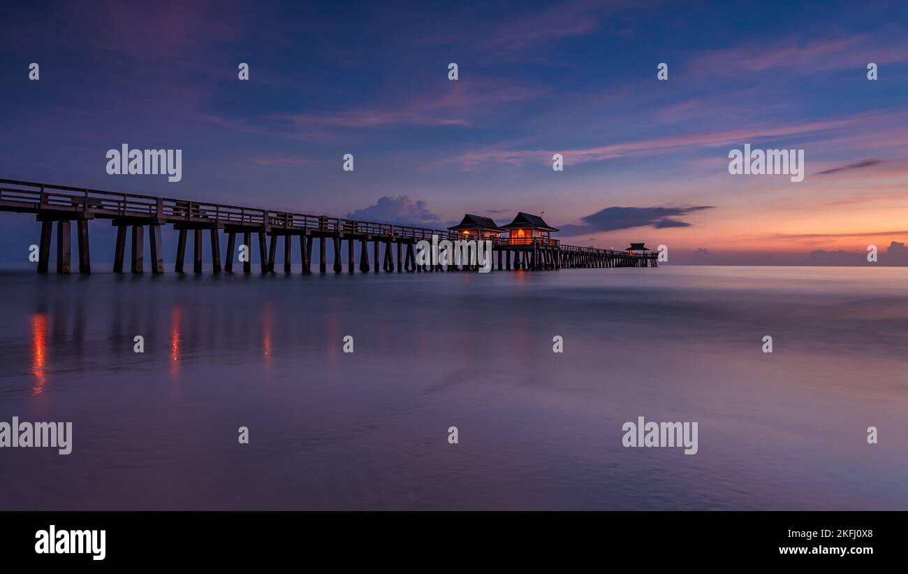 The beautiful Old Naples Pier over water in Florida at sunset Stock ...