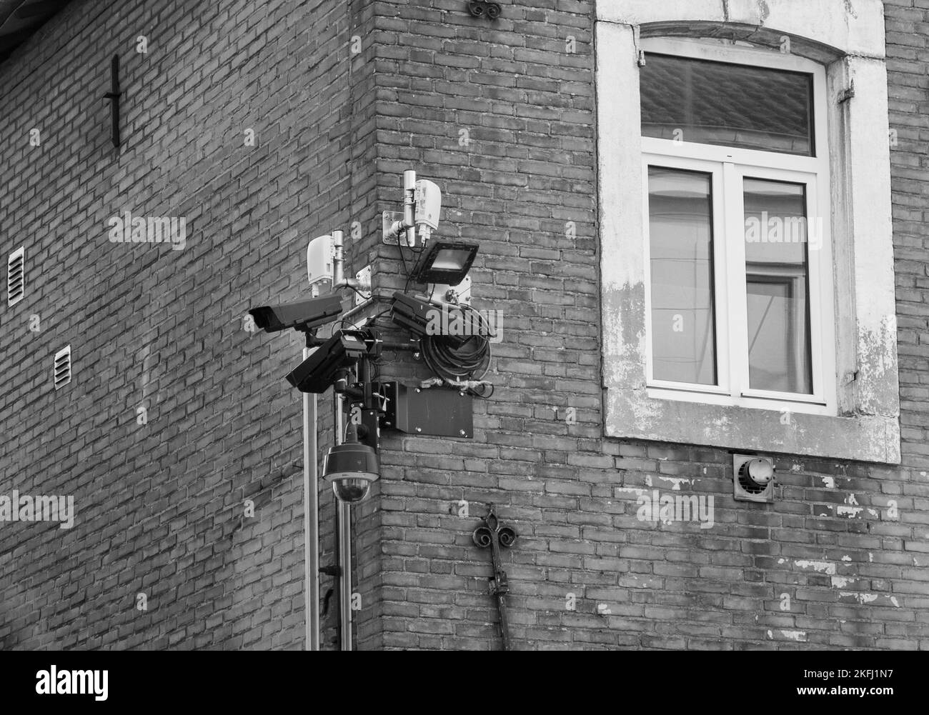 A group of security cameras mounted on the brick building wall Stock ...