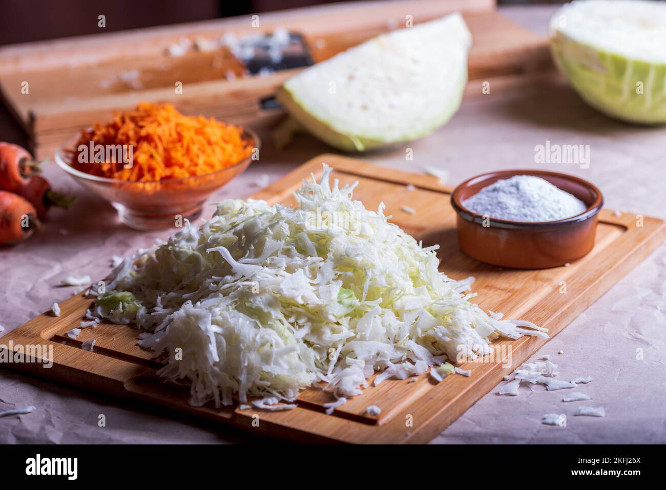 Prepare cabbage for fermentation. Cutting of cabbage on cutter ...