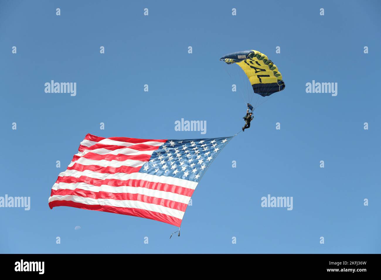 A member of the U.S. Navy SEAL Leap Frogs parachutes while carrying the ...