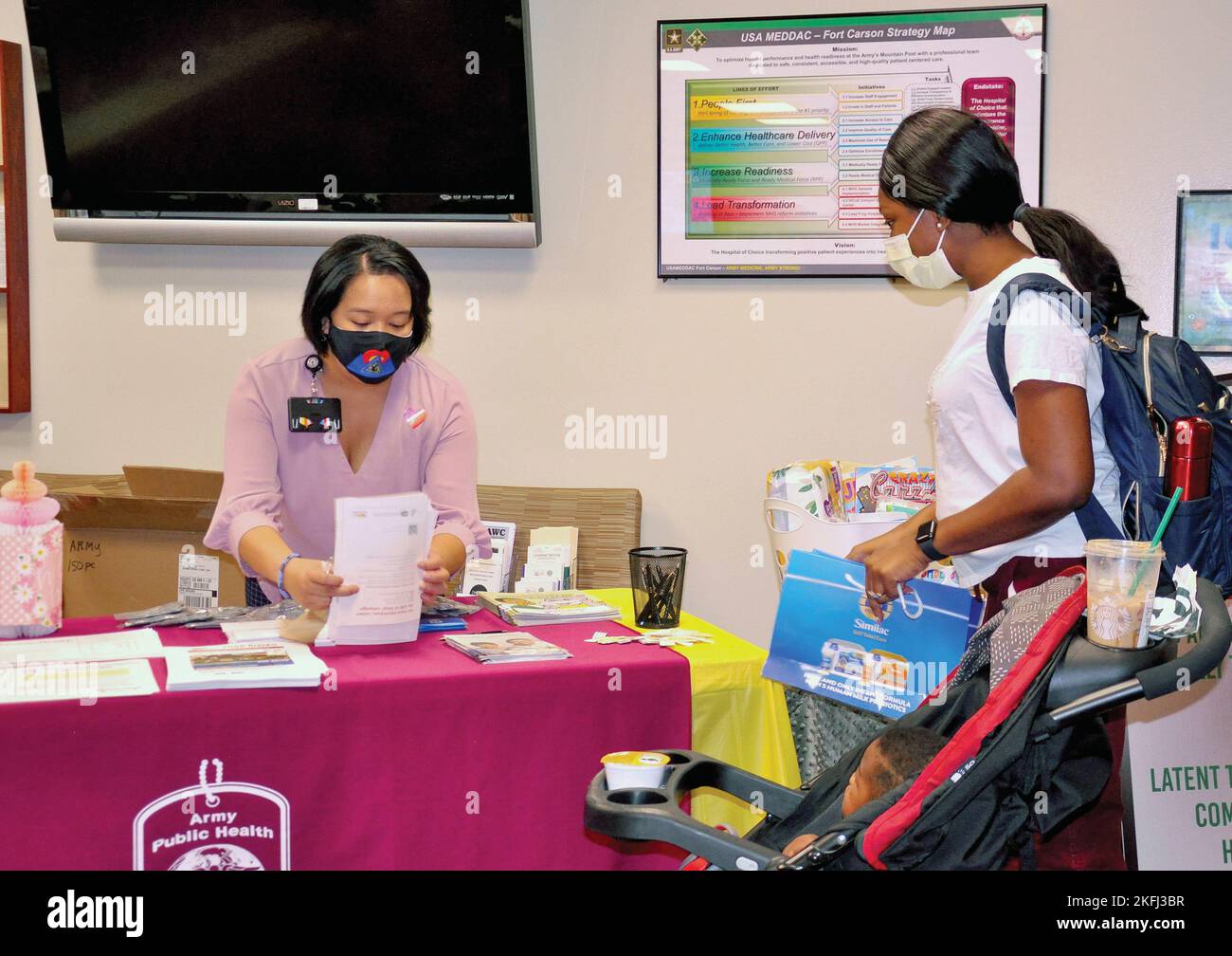 FORT CARSON, Colo. — A mother visits the Army Public Health booth to ...