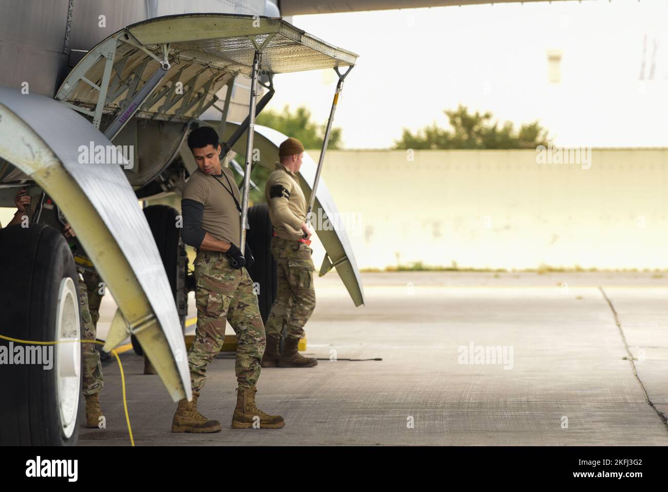 Maintenance Airmen with the 5th Bomb Wing hold the bomb bay doors of a ...