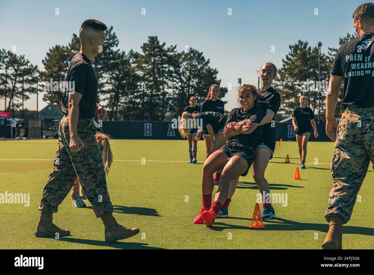 A member of Harvard University’s field hockey team conducts the buddy ...