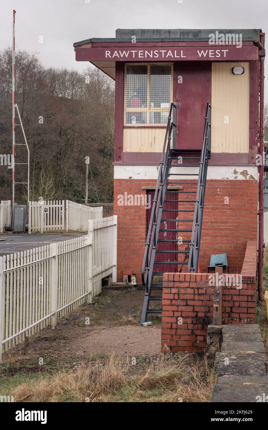 East Lancashire Railway signal box. Maroon paint and red brick walls ...