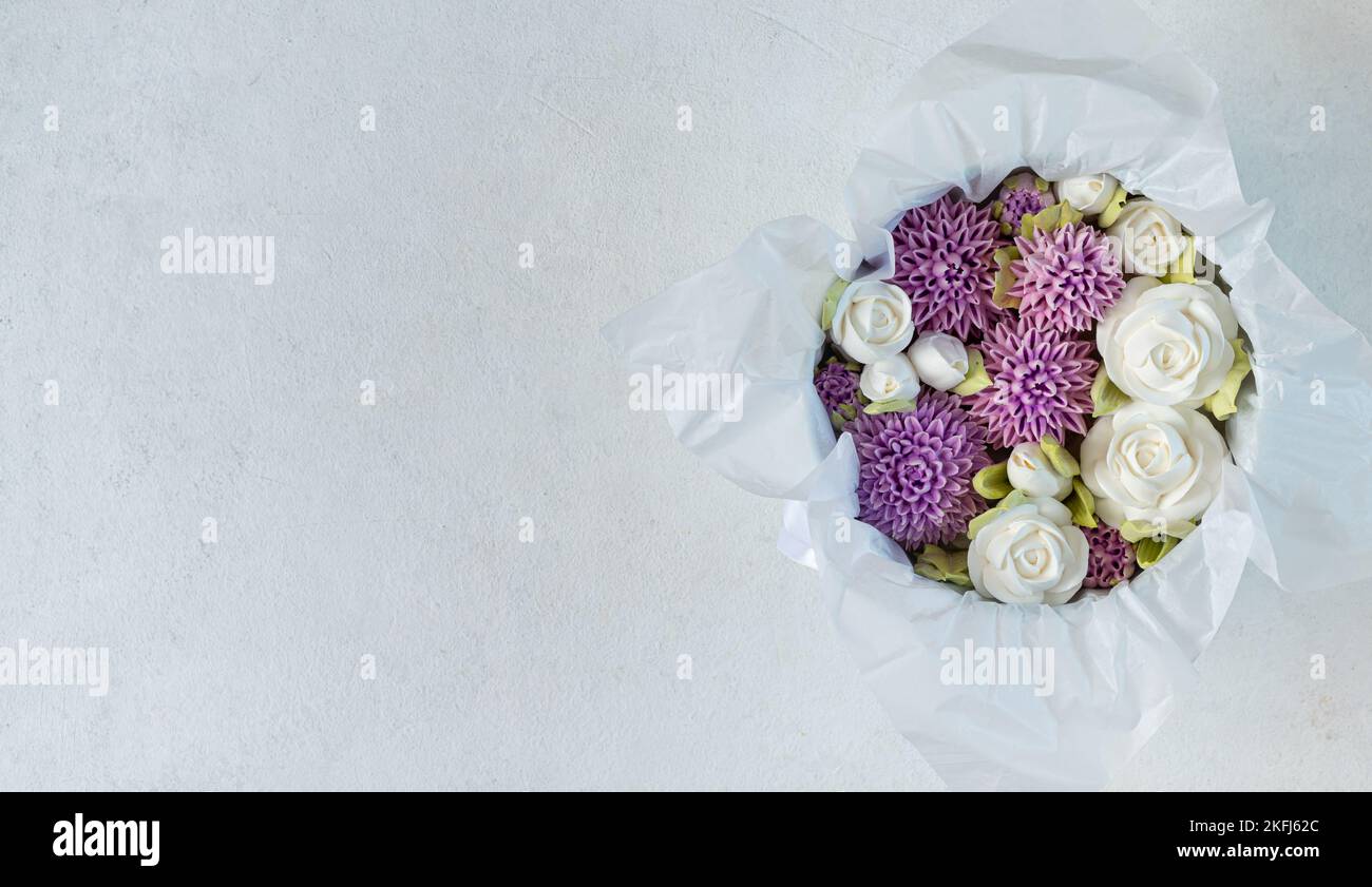 Zephyr bouquet of flowers in a gift box on a light background ...