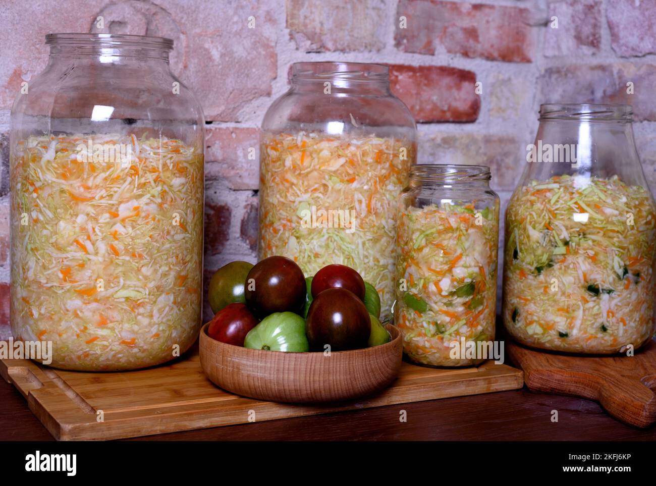 Fermentation preservation Sauerkraut in glass jars, brick background ...