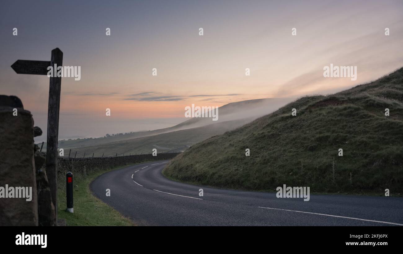 Road over Pendle Hill. Footpath Marker and mist in the distant hills ...