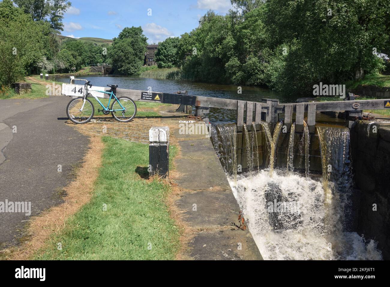 Blue and white peddle bike leaning against the canal lock gate Stock ...