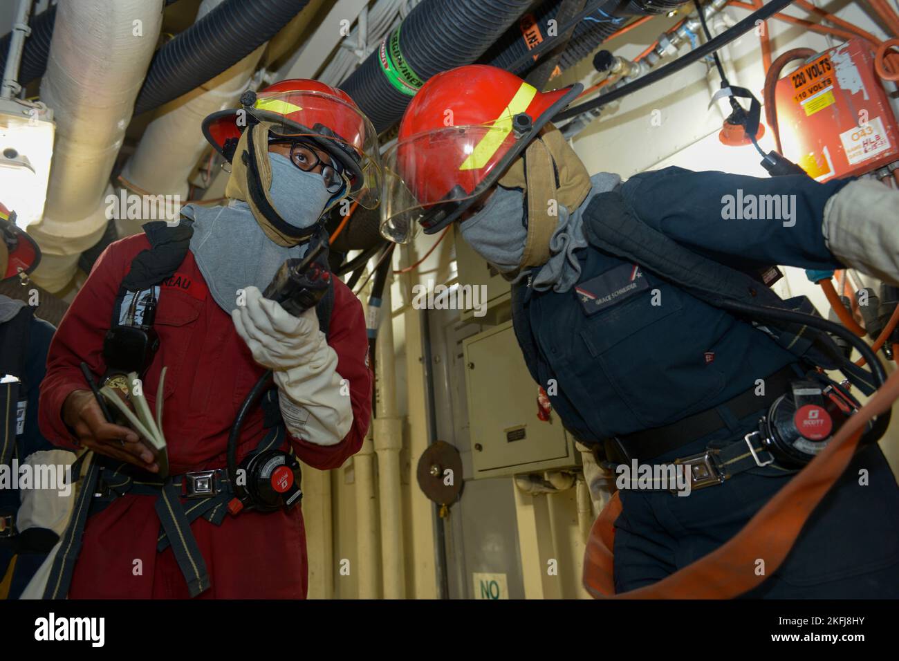 U.S. Navy Damage Controlman 3rd Class Sebastian Moreau, left, from ...
