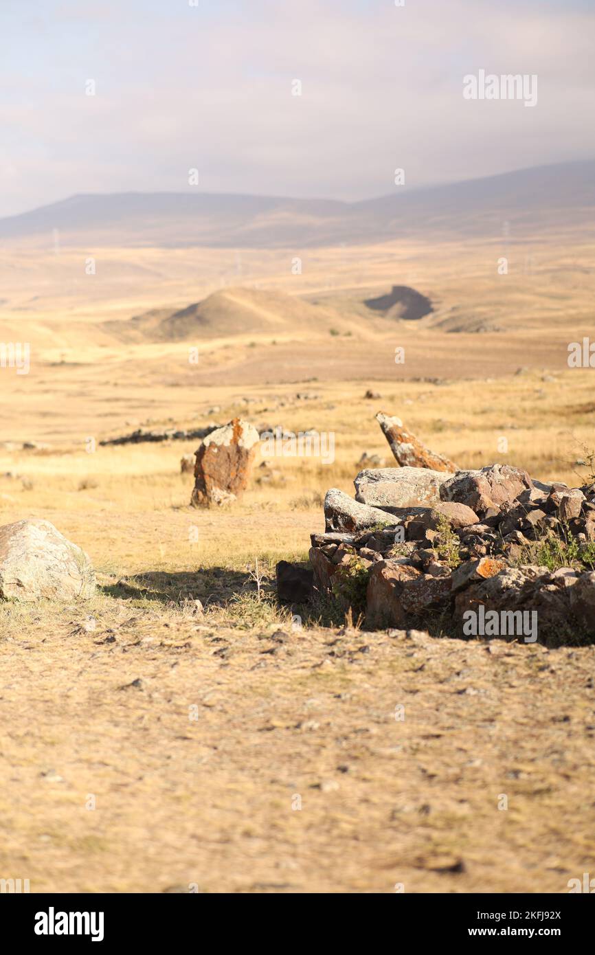 A pile of rocks covered with grass, in an archaeological site in ...