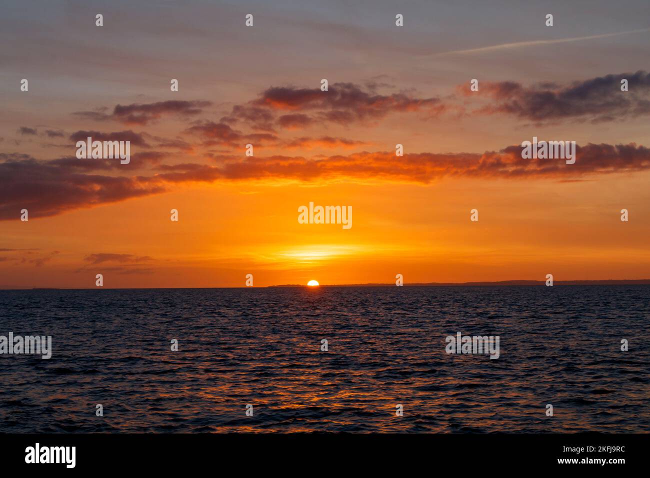 Sun disappearing over the horizon Stock Photo - Alamy