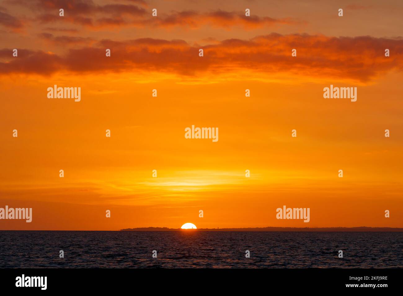 Sun disappearing over the horizon Stock Photo - Alamy