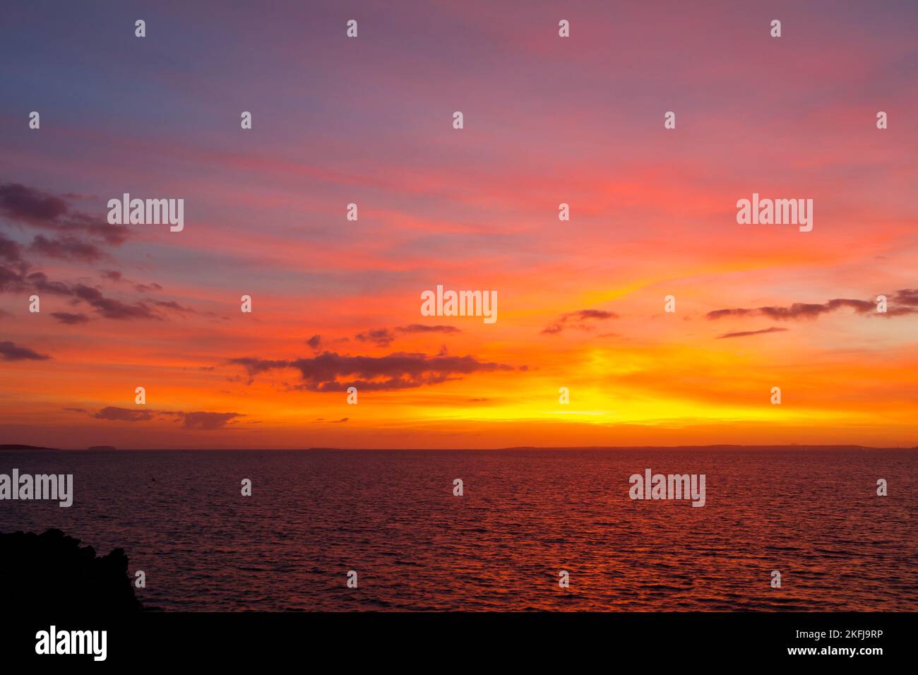 The setting sun lighting up the cloud cover with a slight pinkish hue ...