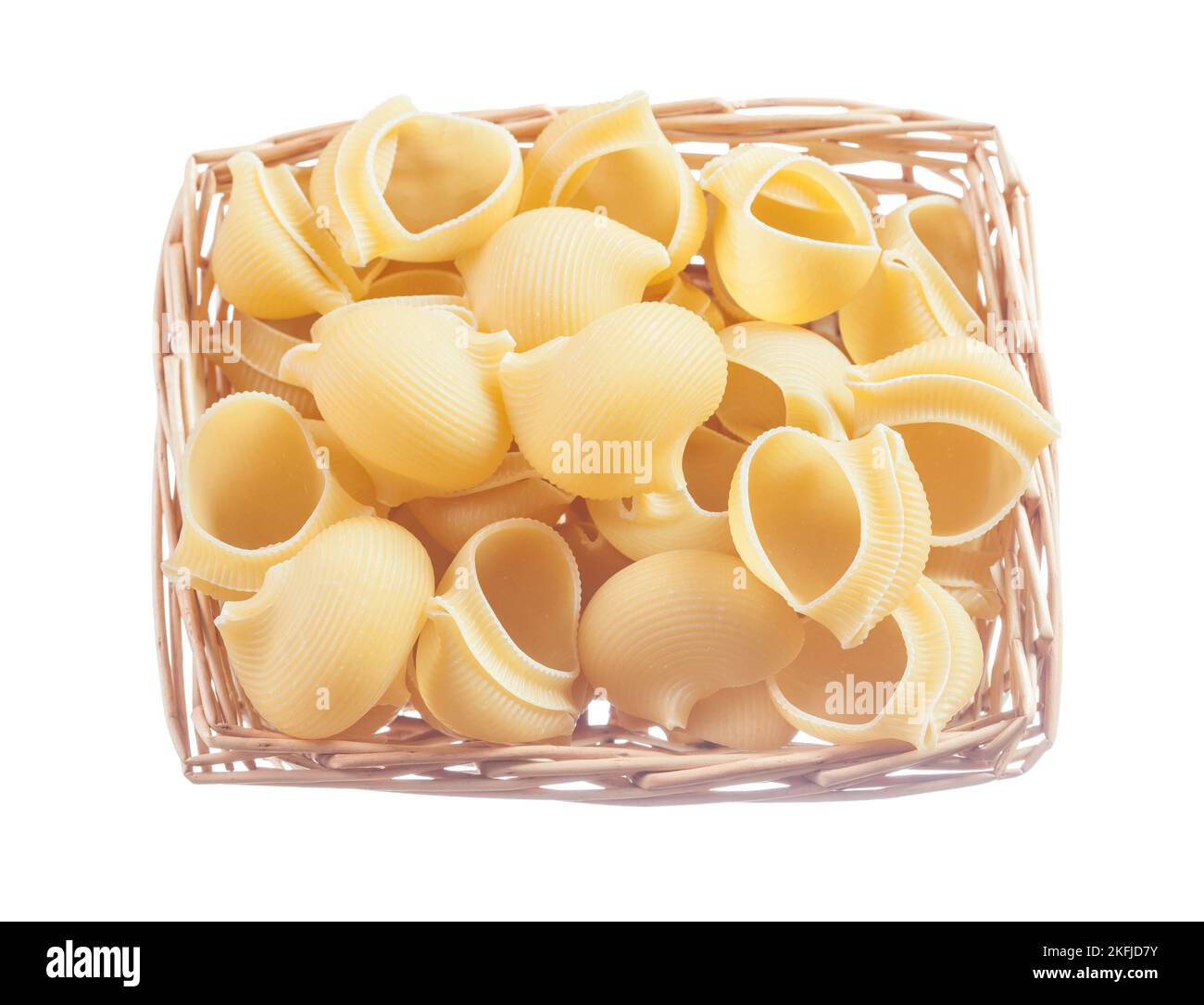 Basket of pasta shells isolated on white Stock Photo - Alamy