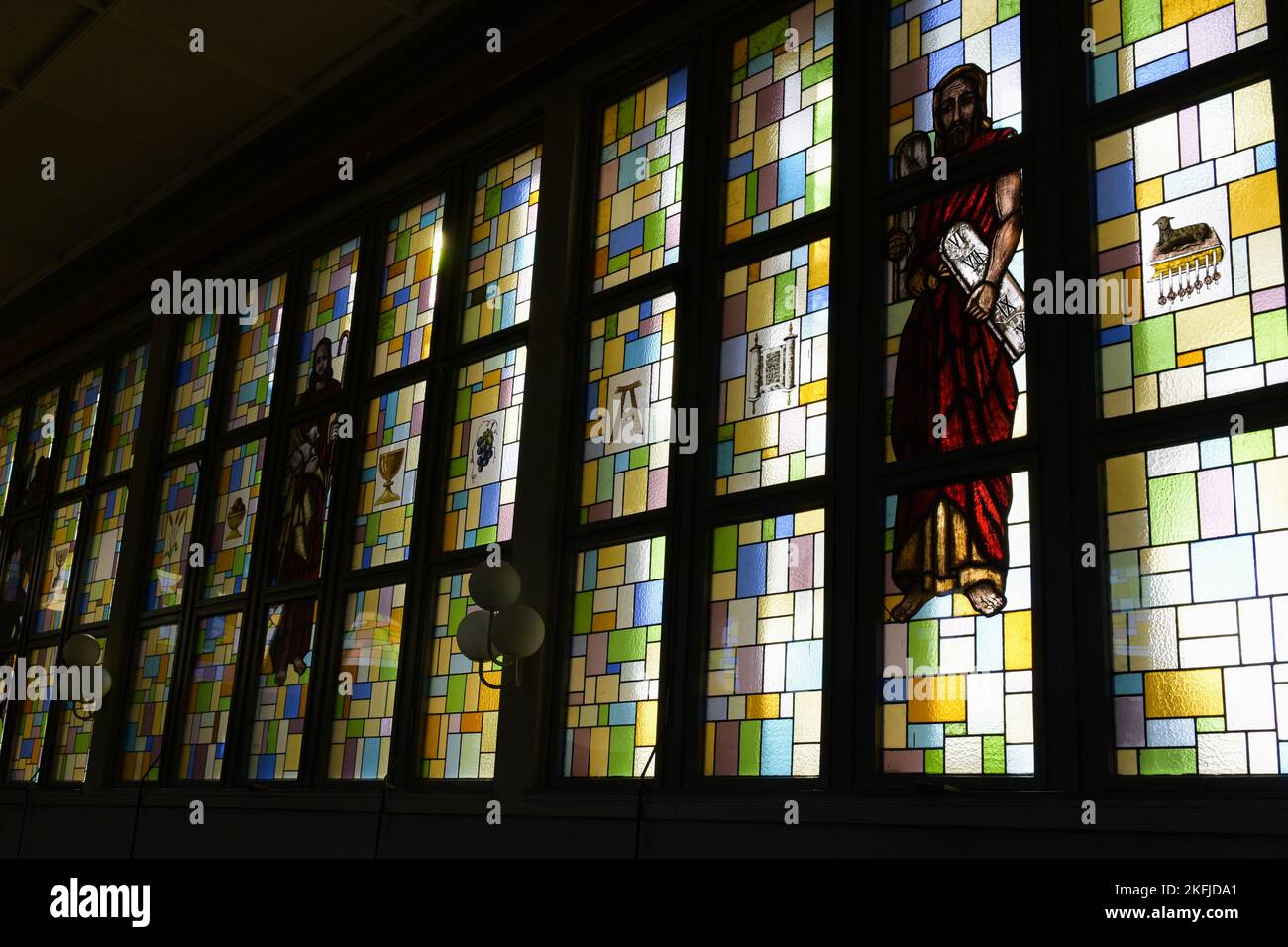 The sun shines through stained-glass windows in the South Side Chapel ...