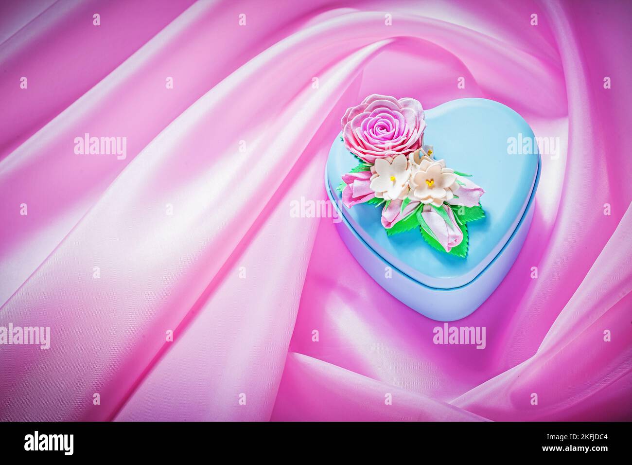 Blue gift box with present on pink fabric background celebrations ...